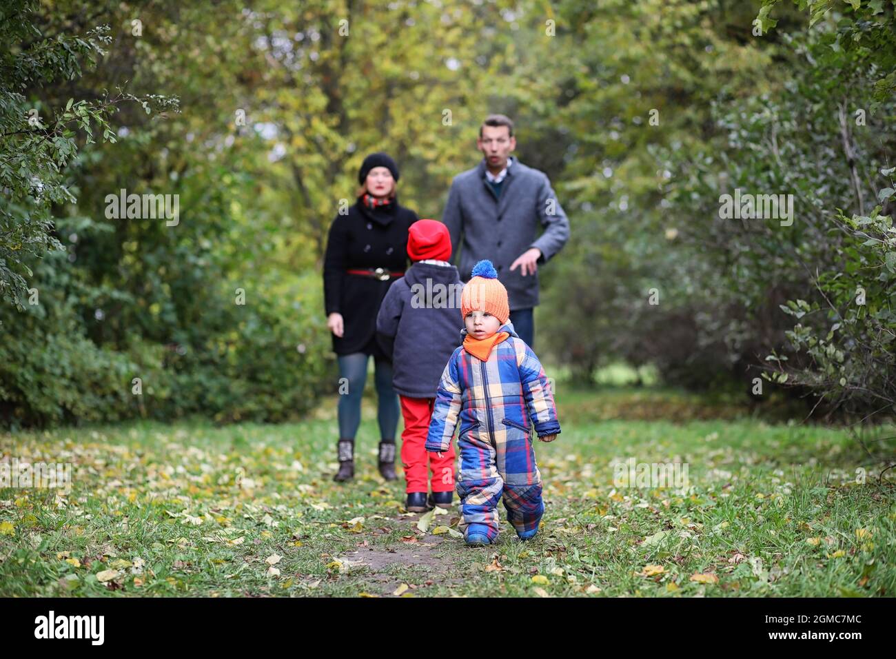 Young family with children on a walk in the park in spring Stock Photo ...