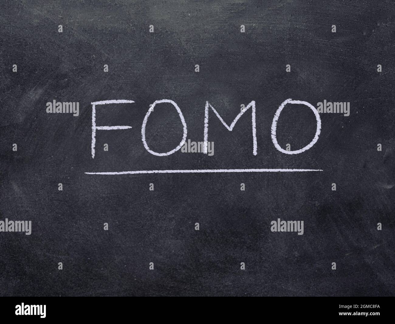 FOMO concept word on blackboard background Stock Photo - Alamy