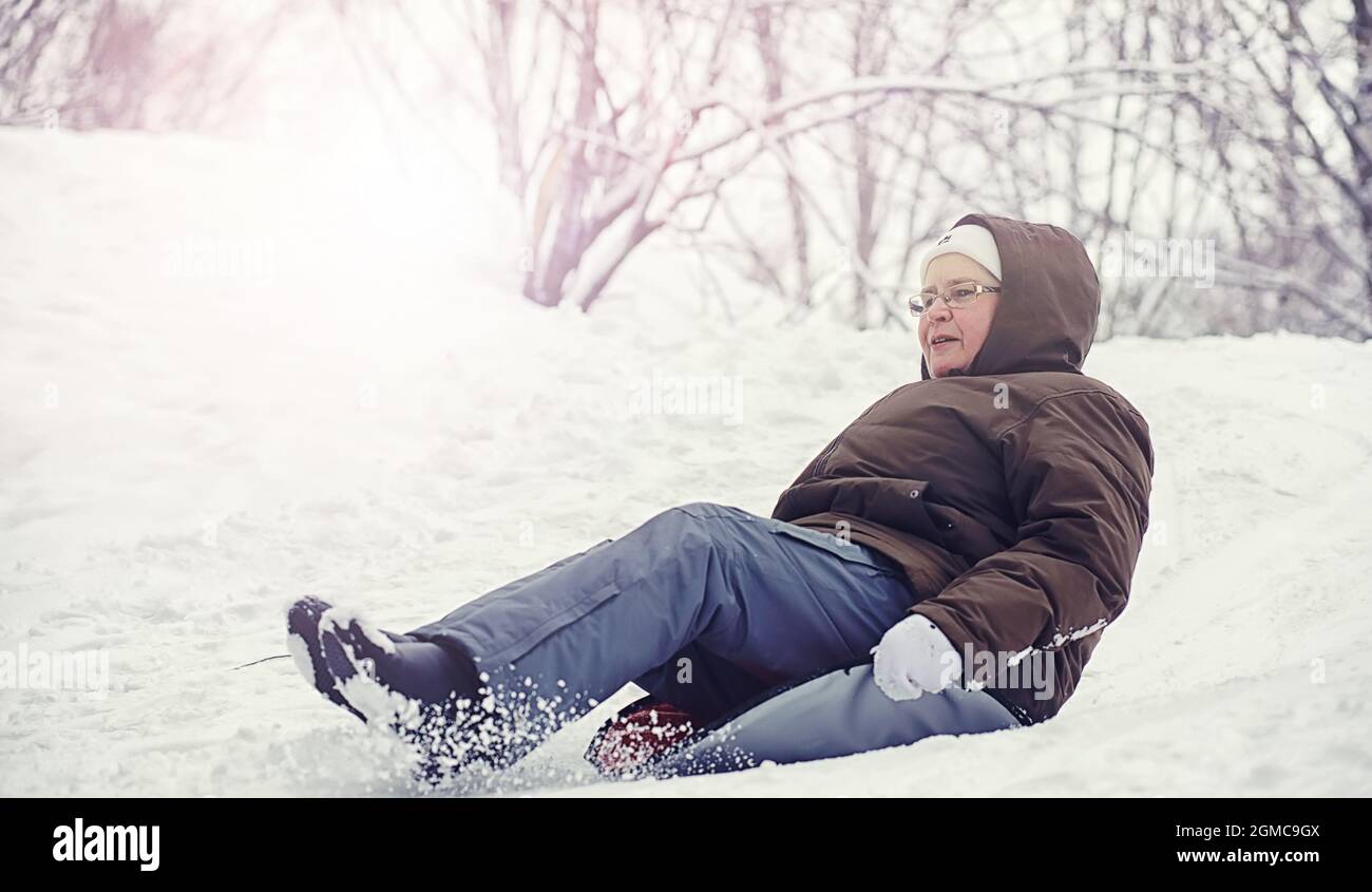 Children in the park in winter. Kids play with snow on playground. They ...