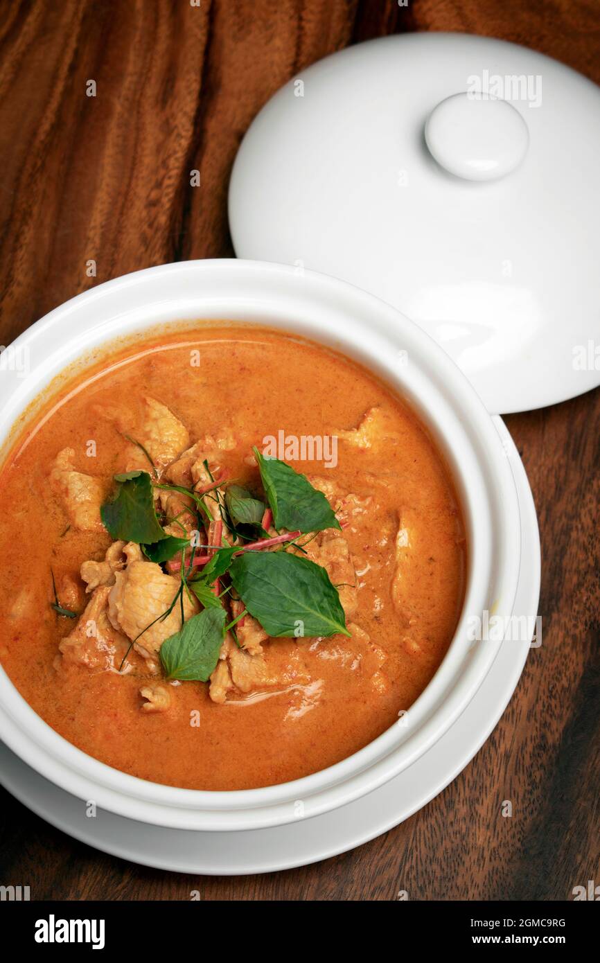thai spicy panang pork curry with coconut milk on wood table in Phuket ...