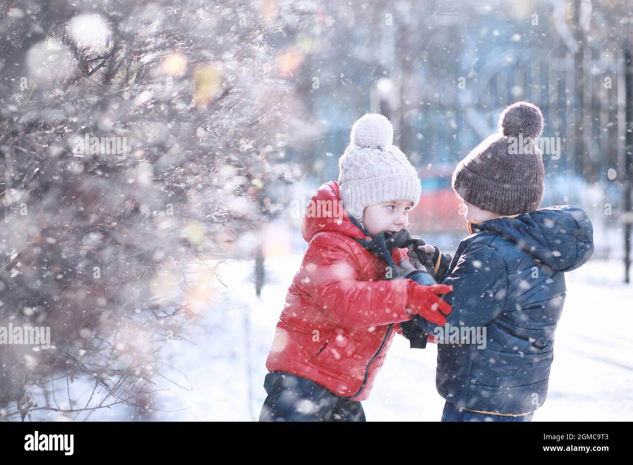 Kids walk in the park with first snow Stock Photo - Alamy
