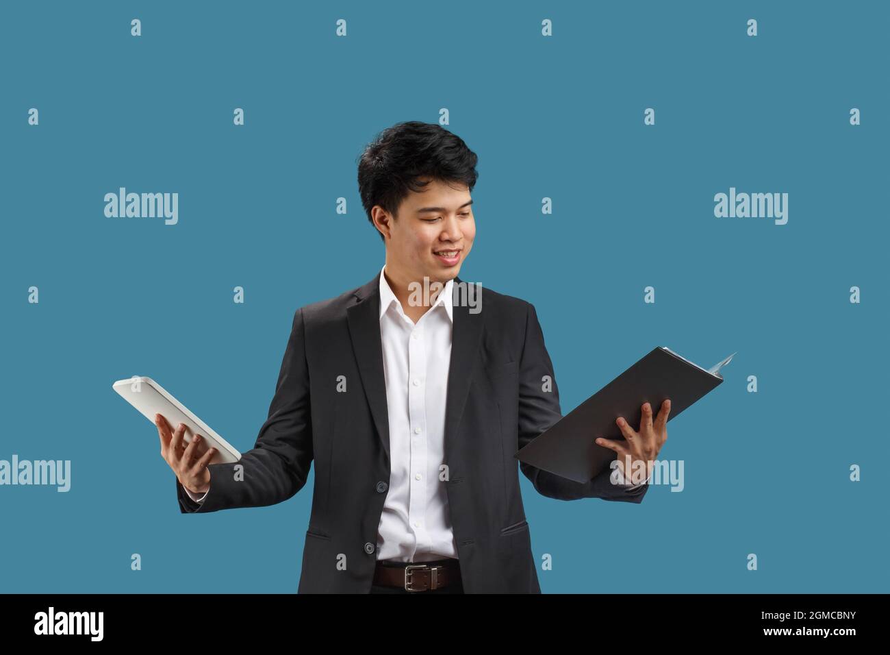 Confused young business man reading document Stock Photo - Alamy