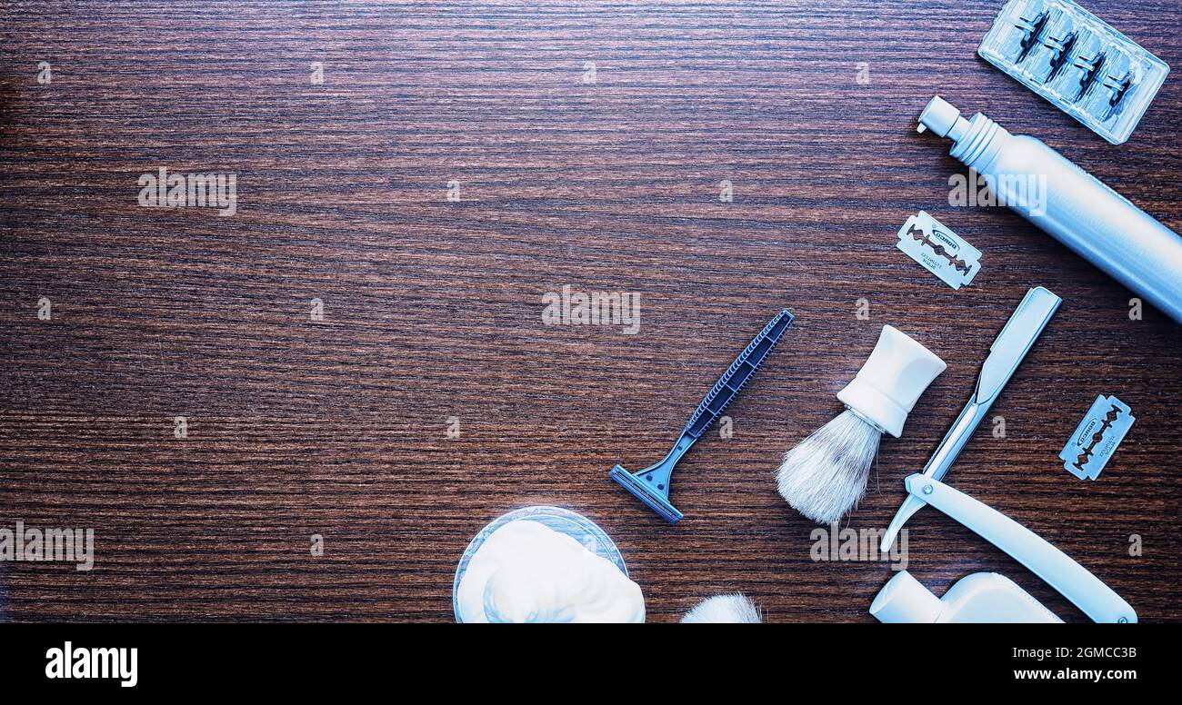 Shaving accessories on a wooden texture background. Tools. Disposable ...