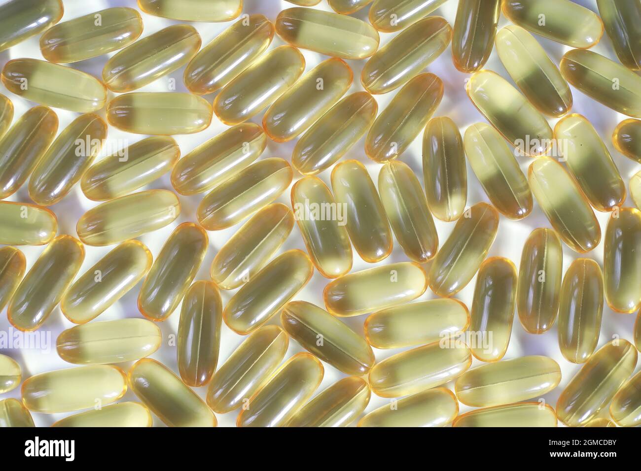 Medical medicines and supplements transparent capsules of yellow color ...