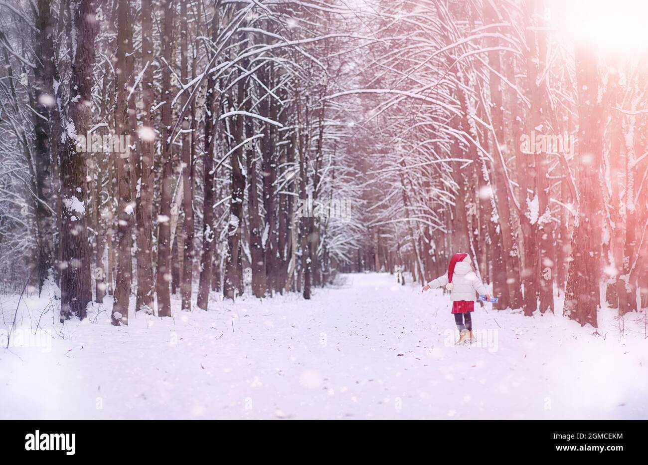 Winter fairy tale, a young mother and her daughter ride a sled in the ...