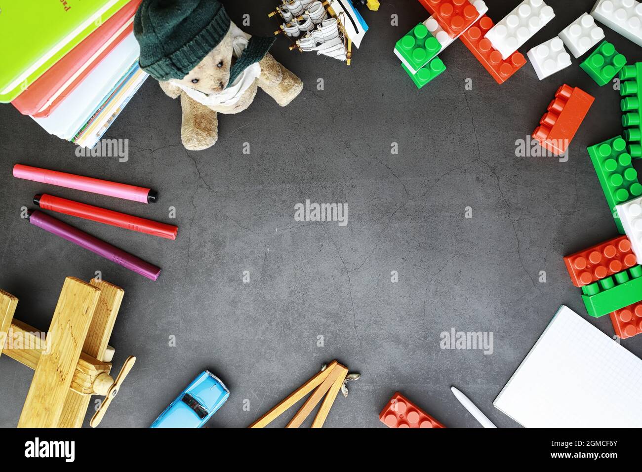Background. Children's toys on the table. The space between kid's toys ...