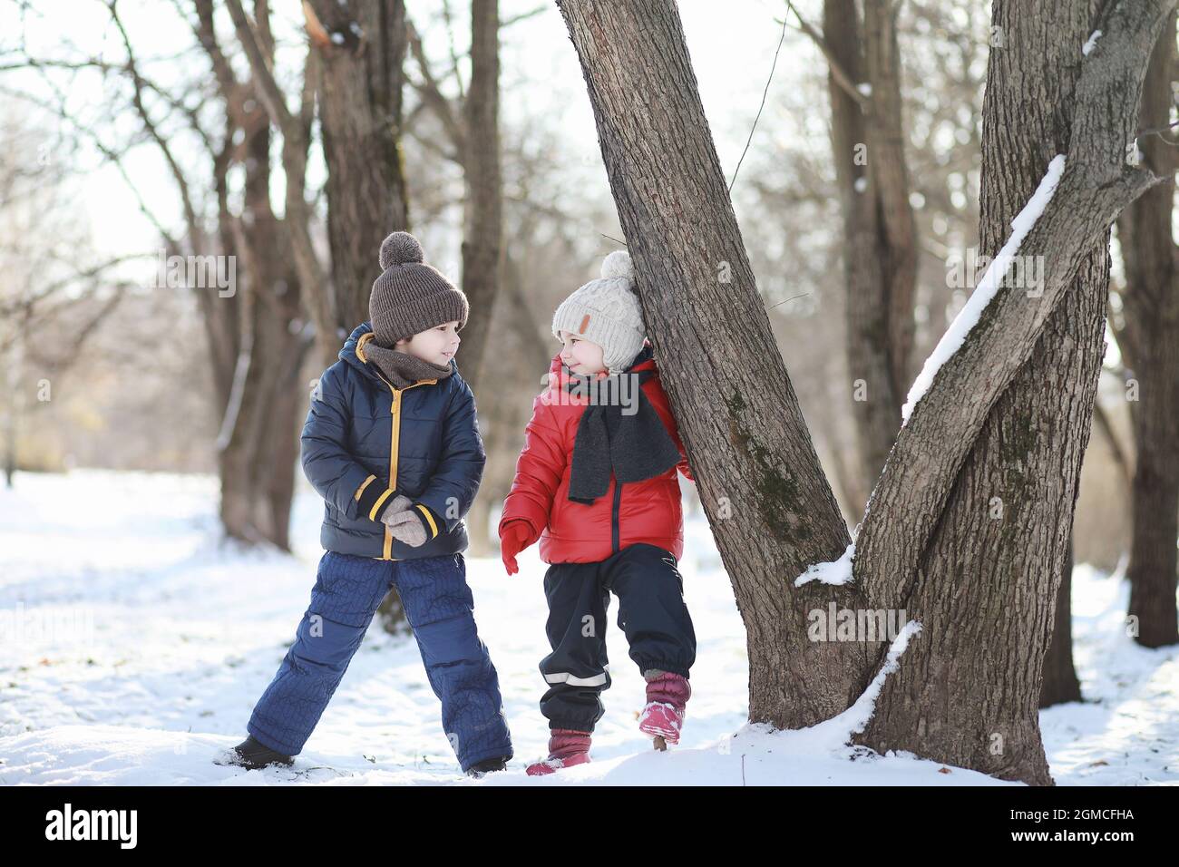 children in winter park play with snow Stock Photo - Alamy