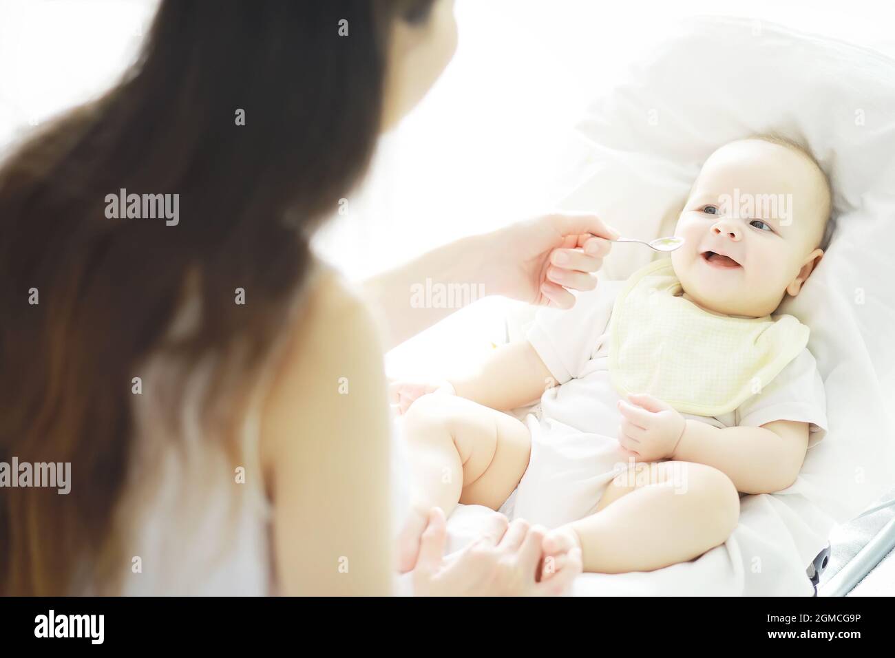 Maternity concept. A young mother feeds her little baby. First lure and ...