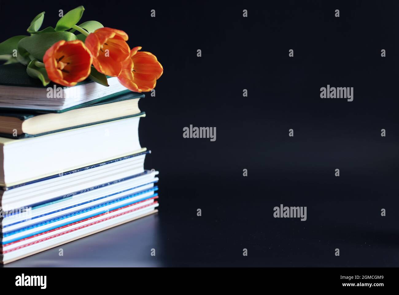 A stack of textbooks and books on table. The concept of knowledge and ...