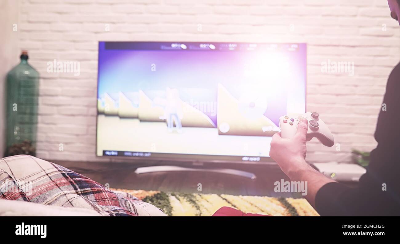 Playing on the console. Man is playing a game while lying on the floor ...