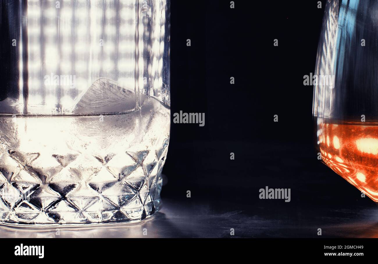 A glass of hard alcohol with ice on a bar counter. Whiskey with soda in ...
