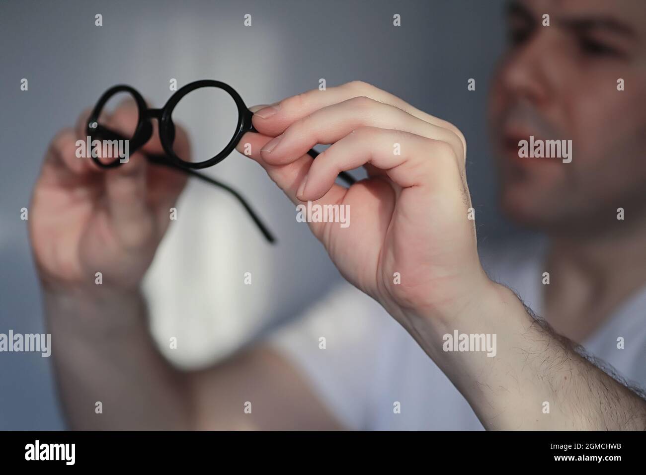 The concept of poor vision. Hold a contact lens and glasses in hand ...