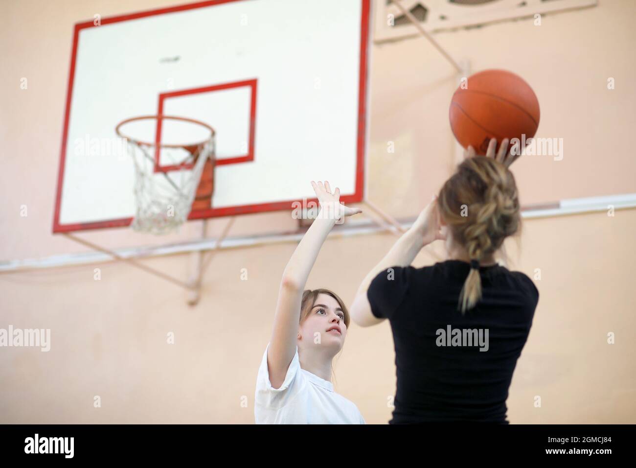 Girl young student in the gym playing a basketball Stock Photo - Alamy