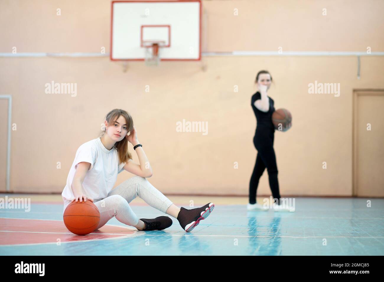 Girl young student in the gym playing a basketball Stock Photo - Alamy