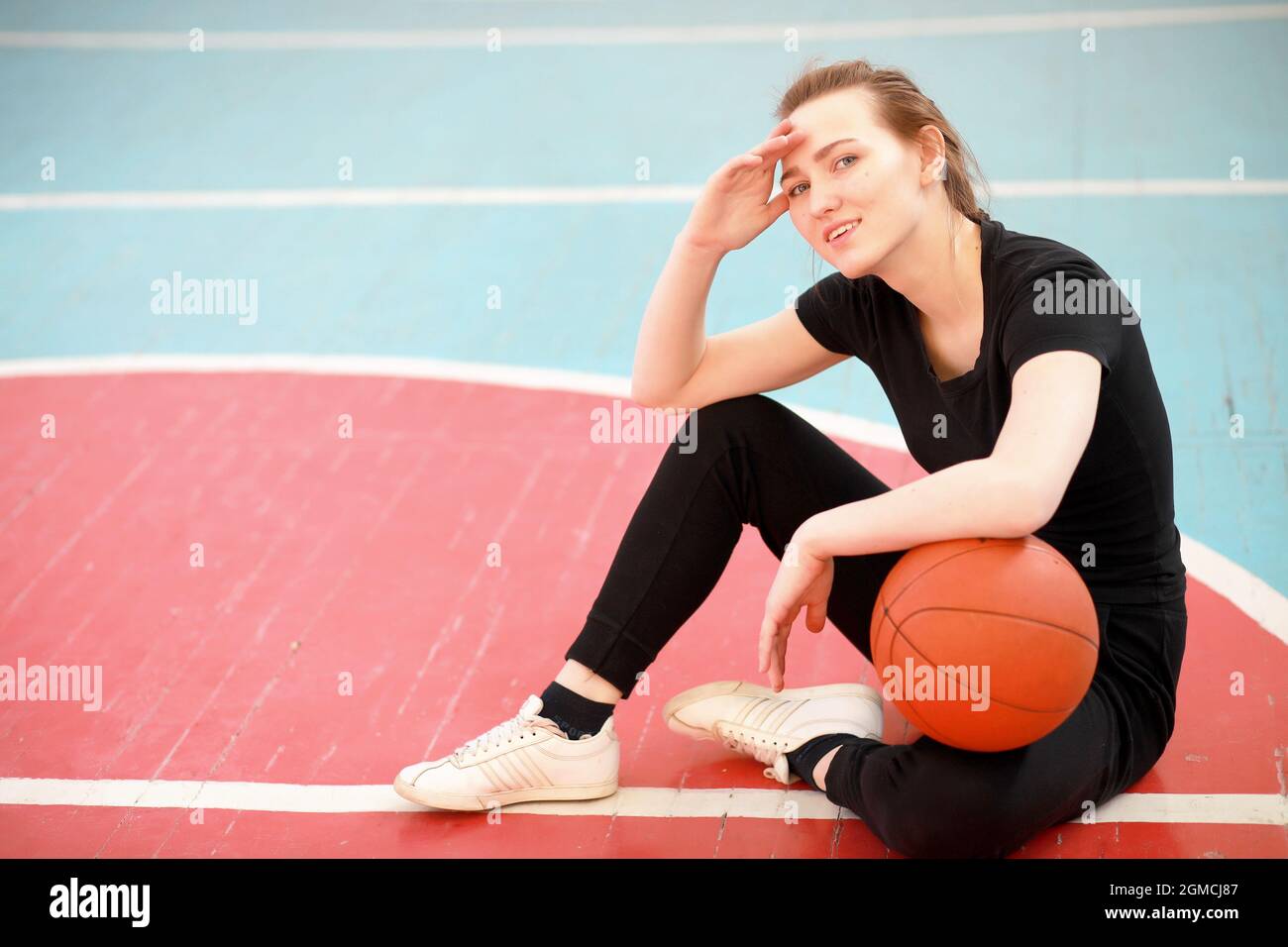 Girl young student in the gym playing a basketball Stock Photo - Alamy