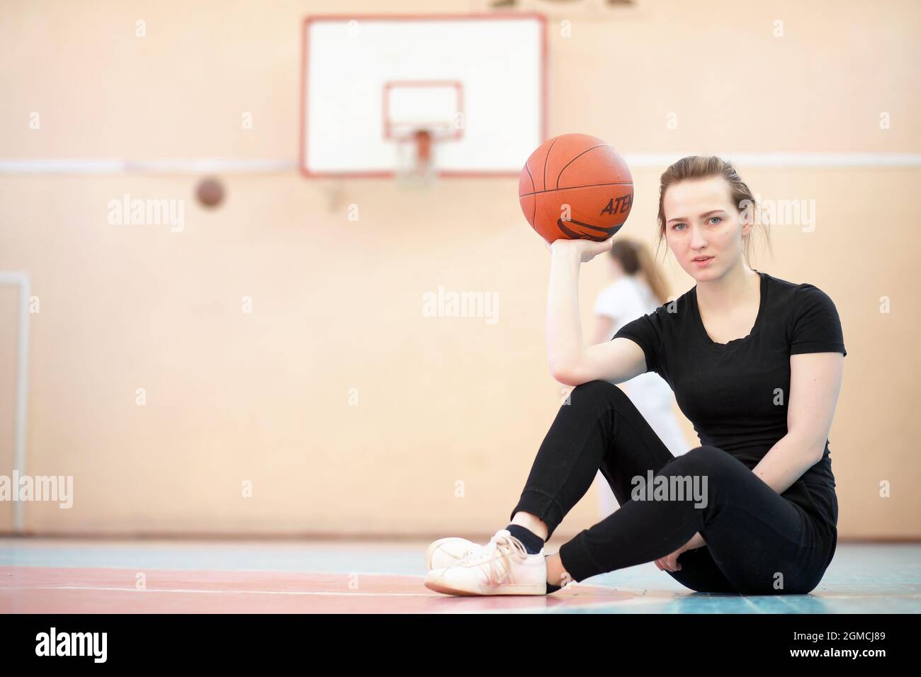 Girl young student in the gym playing a basketball Stock Photo - Alamy