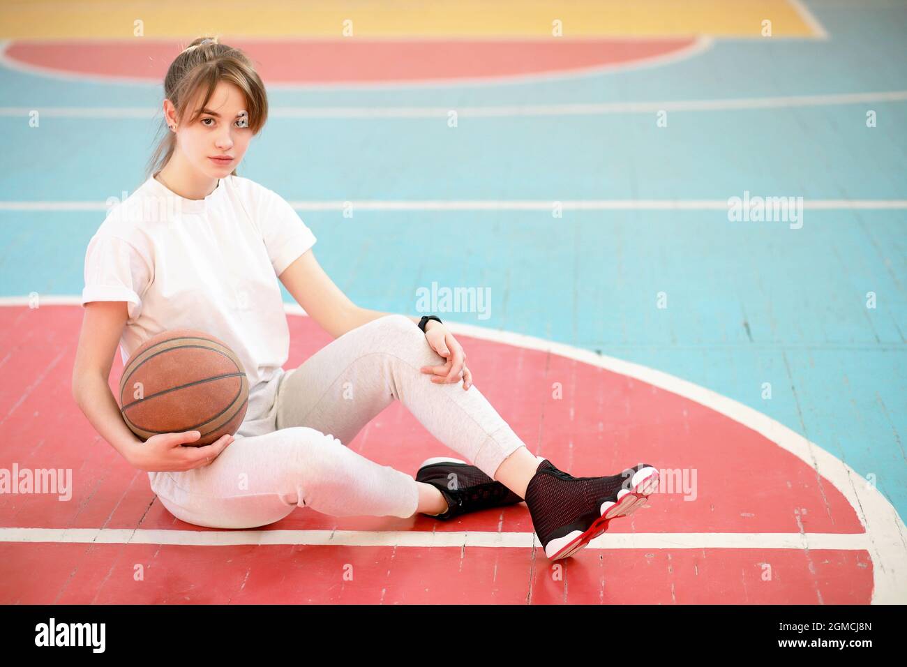 Girl young student in the gym playing a basketball Stock Photo - Alamy