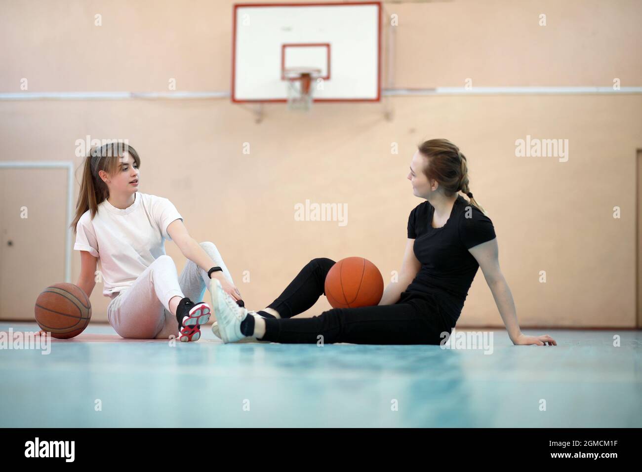 Girl young student in the gym playing a basketball Stock Photo - Alamy