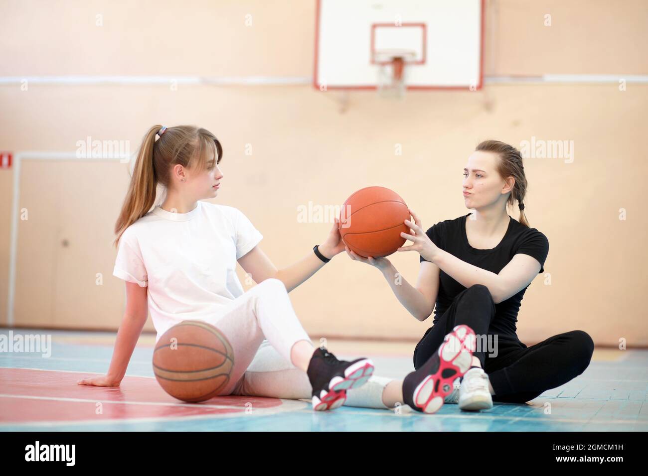 Girl young student in the gym playing a basketball Stock Photo - Alamy