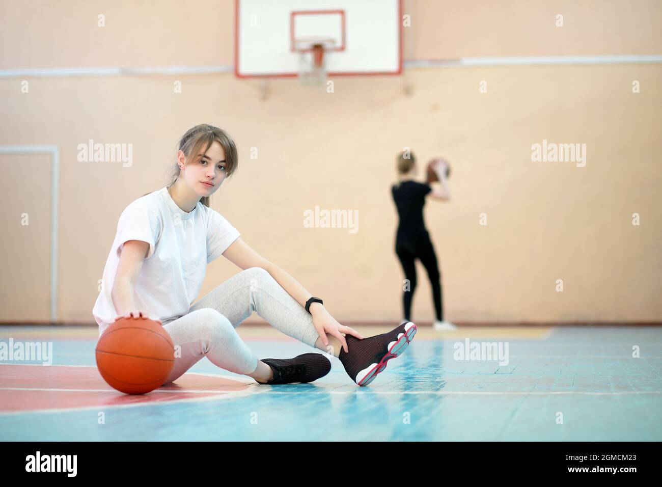 Girl young student in the gym playing a basketball Stock Photo - Alamy