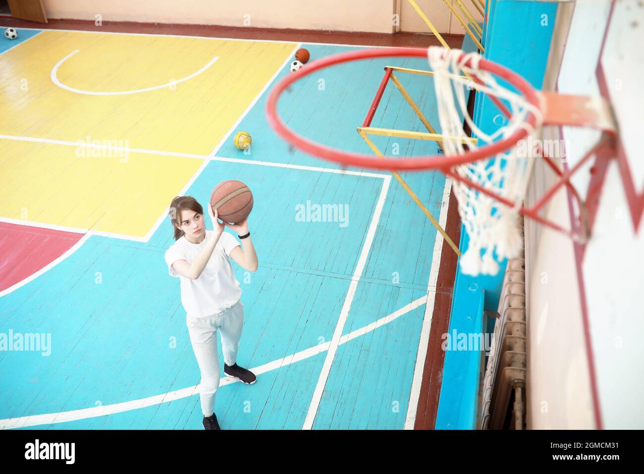 Girl young student in the gym playing a basketball Stock Photo - Alamy