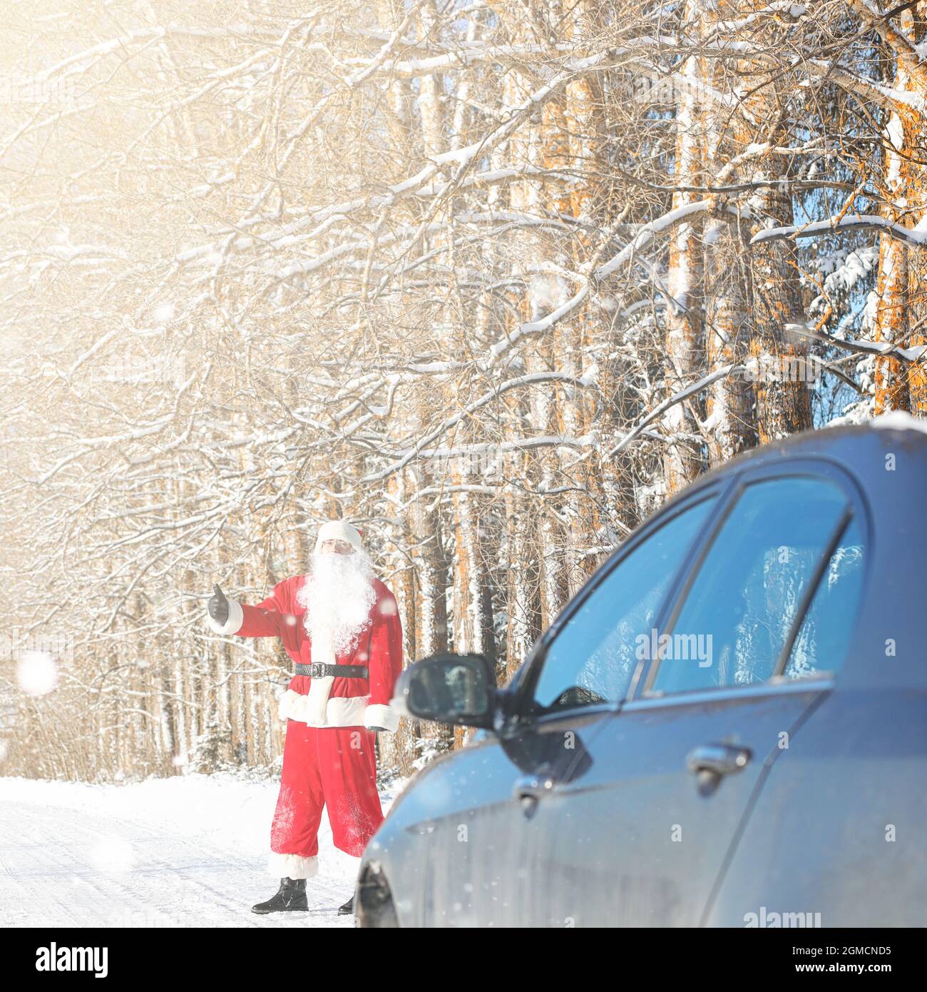 Santa Claus comes with gifts from the outside. Santa in a red suit with ...