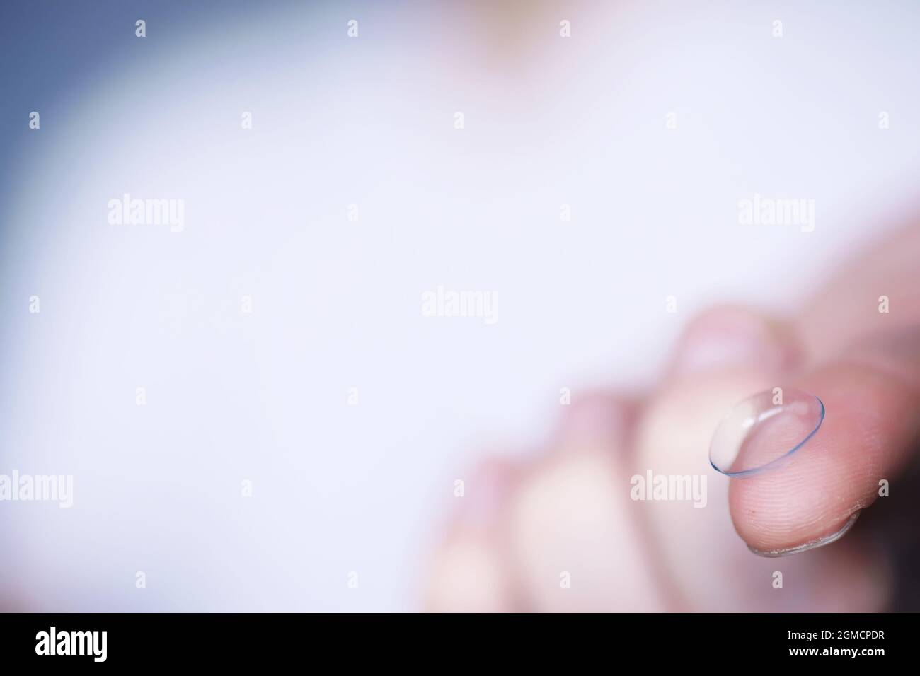 The concept of poor vision. Hold a contact lens and glasses in hand ...