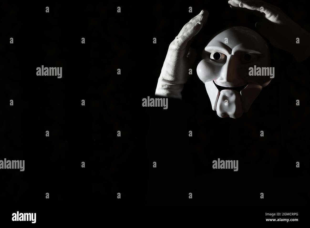 White scary mask on a black background with whites hands Stock Photo ...