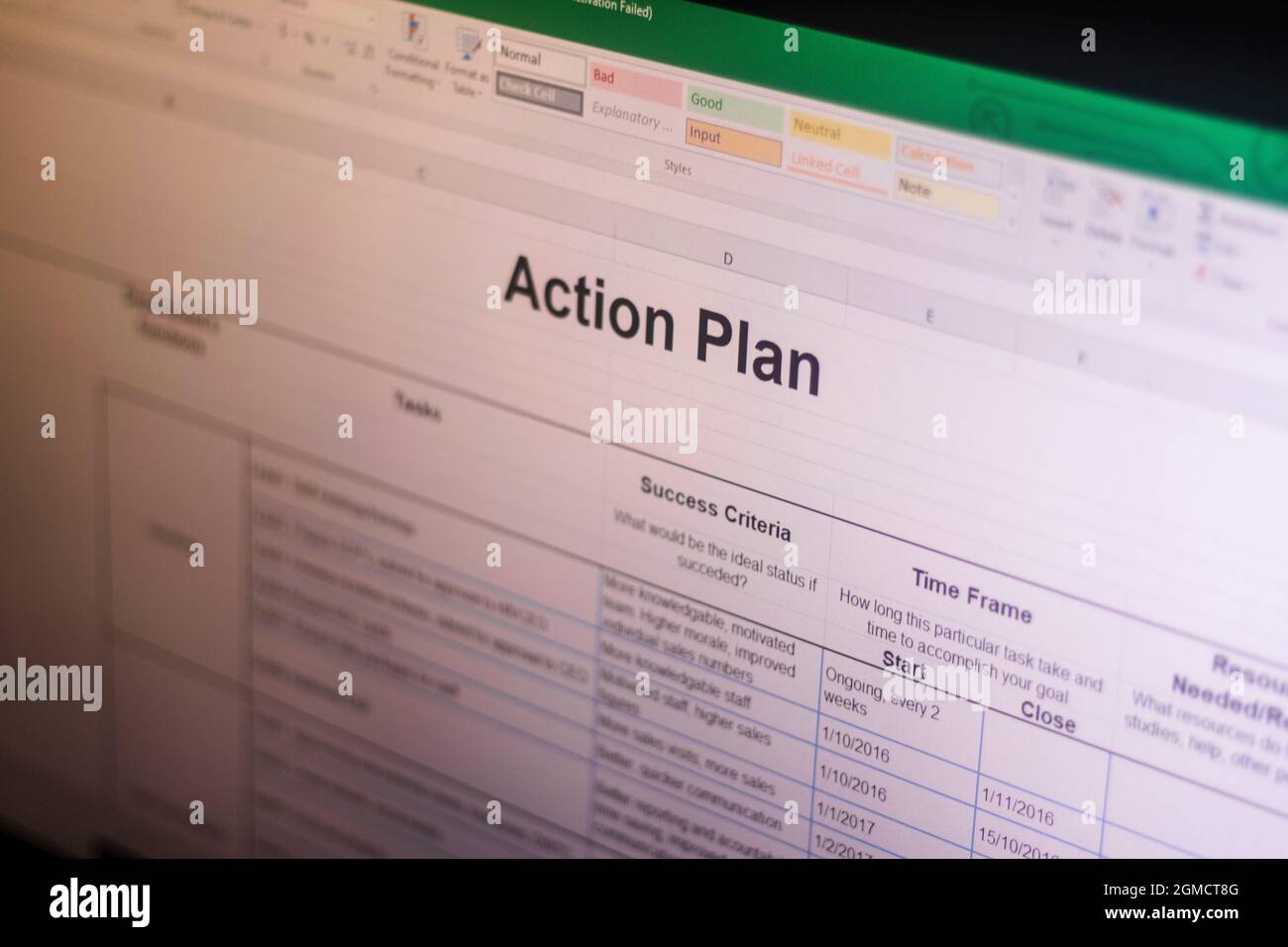Shot of an excel sheet on computer screen showing business action plan ...