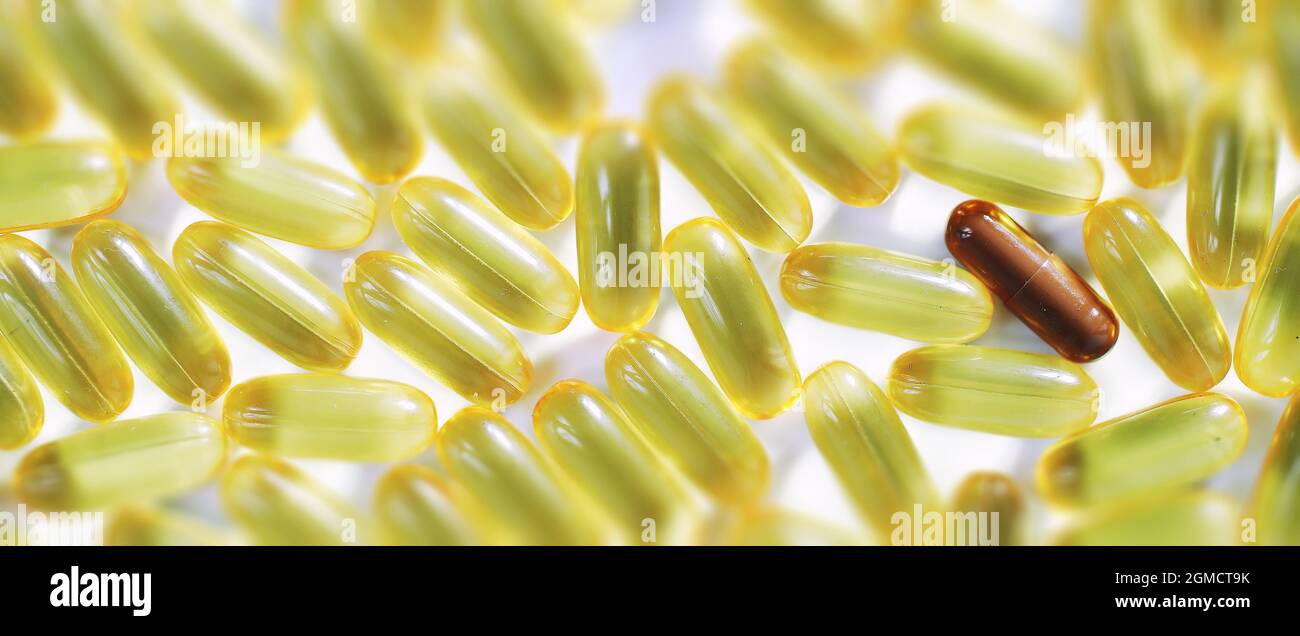 Medical medicines and supplements transparent capsules of yellow color ...