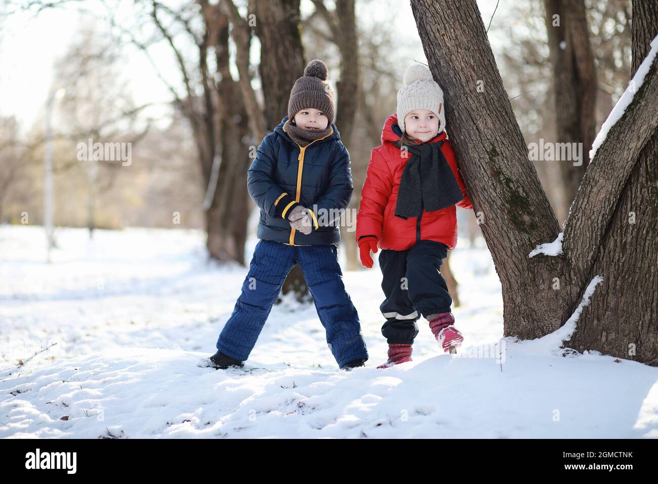 children in winter park play with snow Stock Photo - Alamy