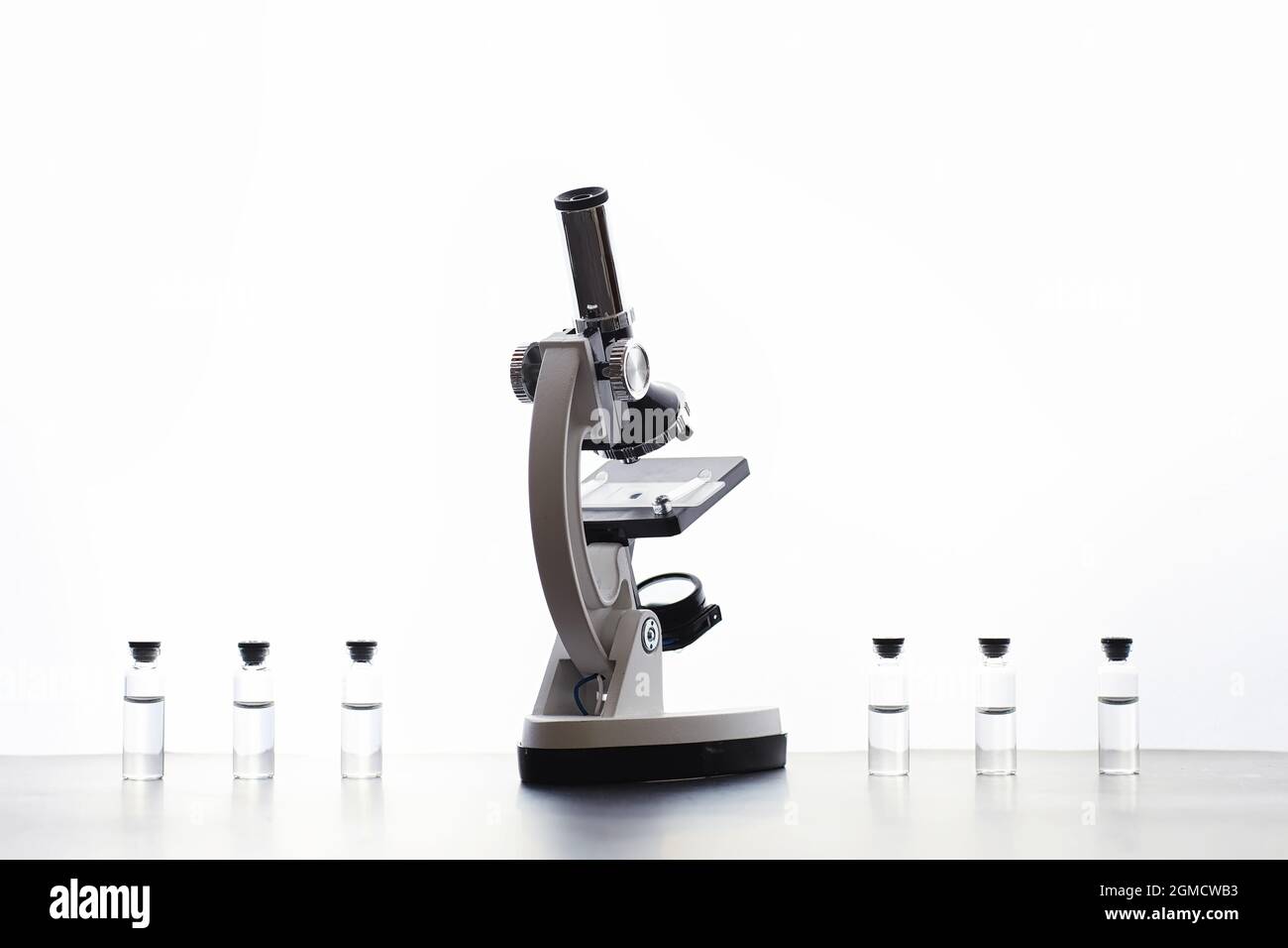 Research laboratory. Test tubes and microscope on the table on a white ...