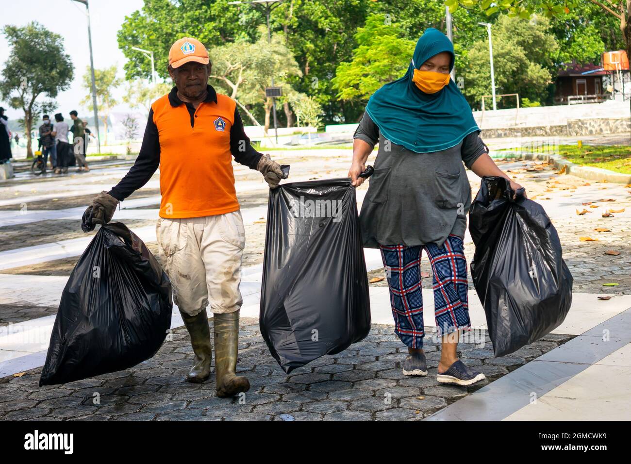 Kendari, Indonesia. 18th Sep, 2021. Garbage collectors carry garbage in ...