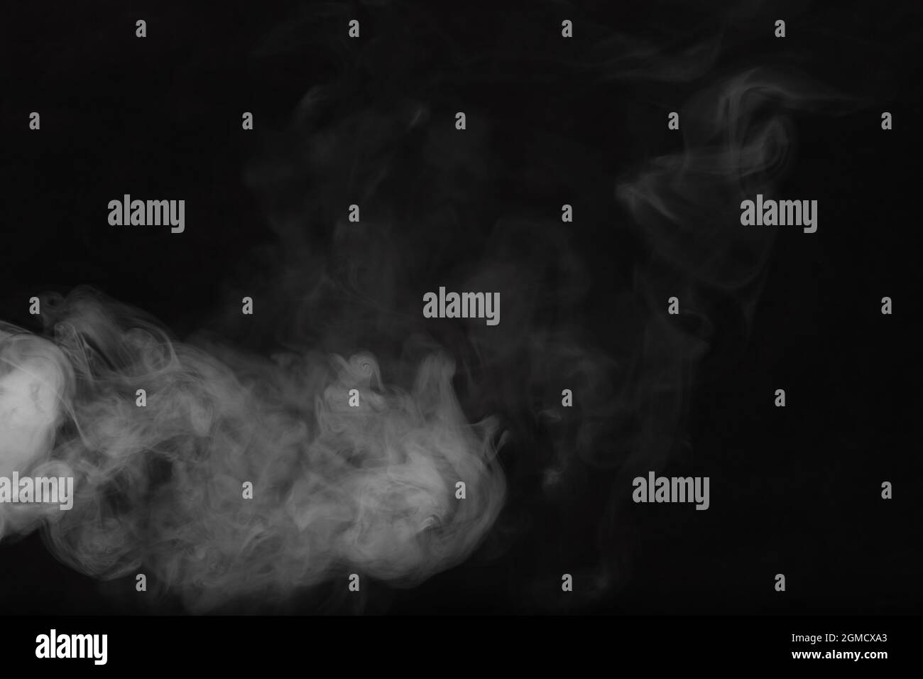White smoke on a black background. Texture of smoke. Clubs of white ...