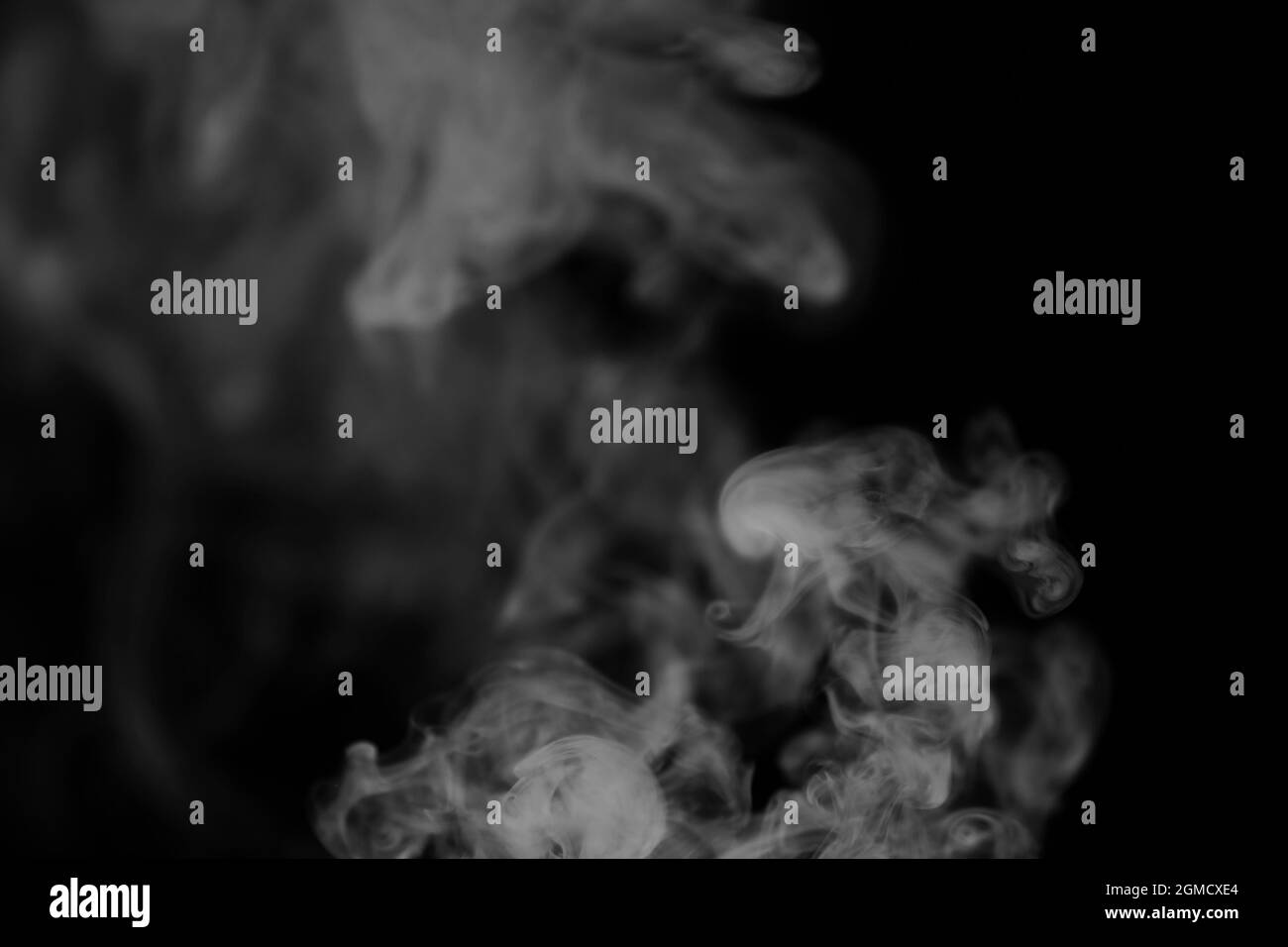 White smoke on a black background. Texture of smoke. Clubs of white ...