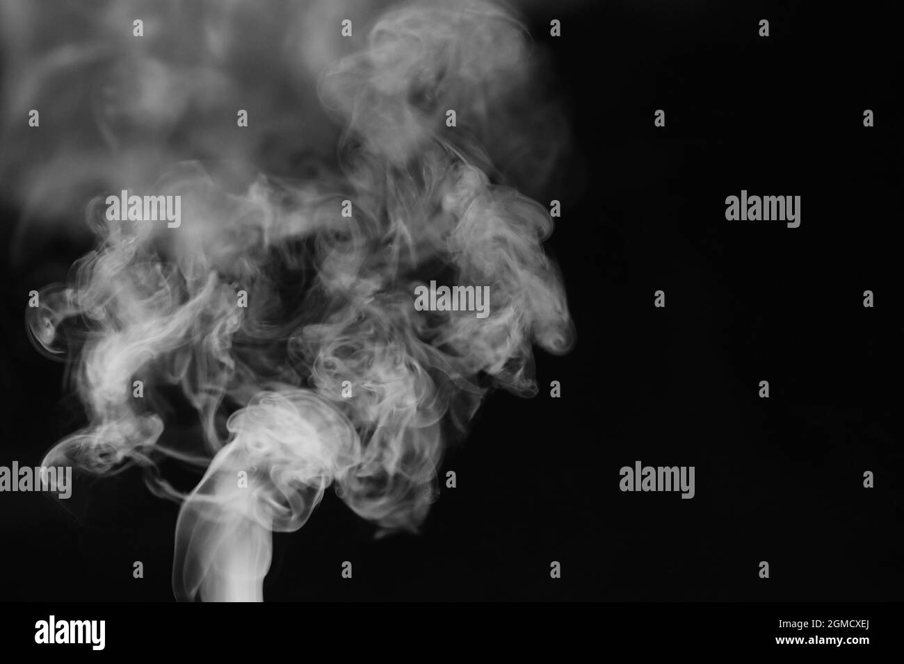 White smoke on a black background. Texture of smoke. Clubs of white ...