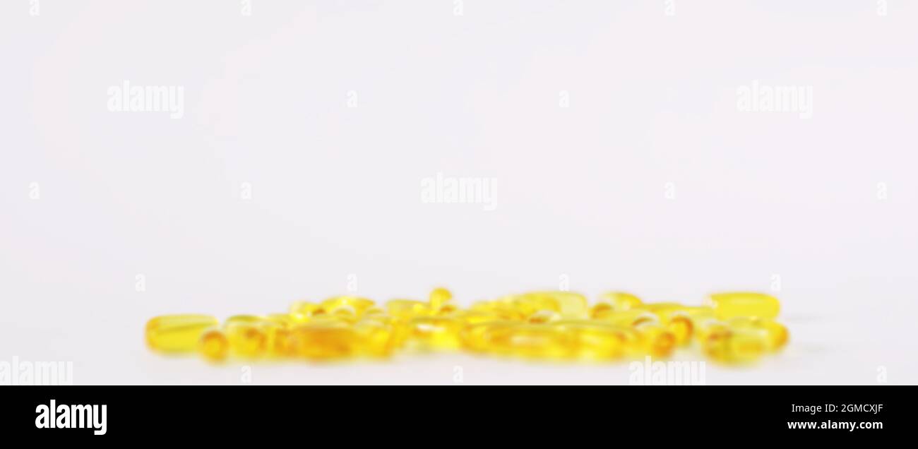 Medical medicines and supplements transparent capsules of yellow color ...