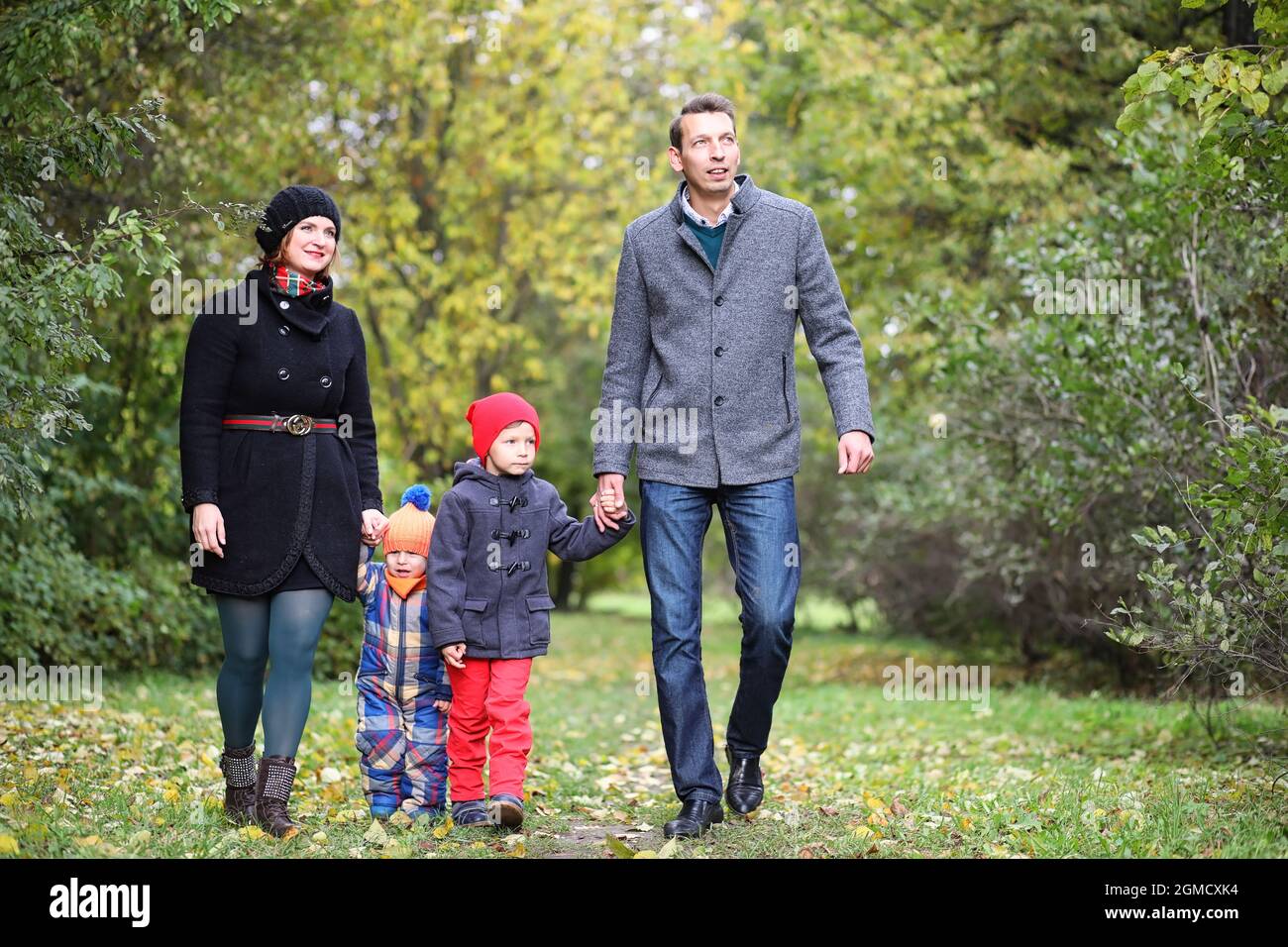 Young family with children on a walk in the park in spring Stock Photo ...