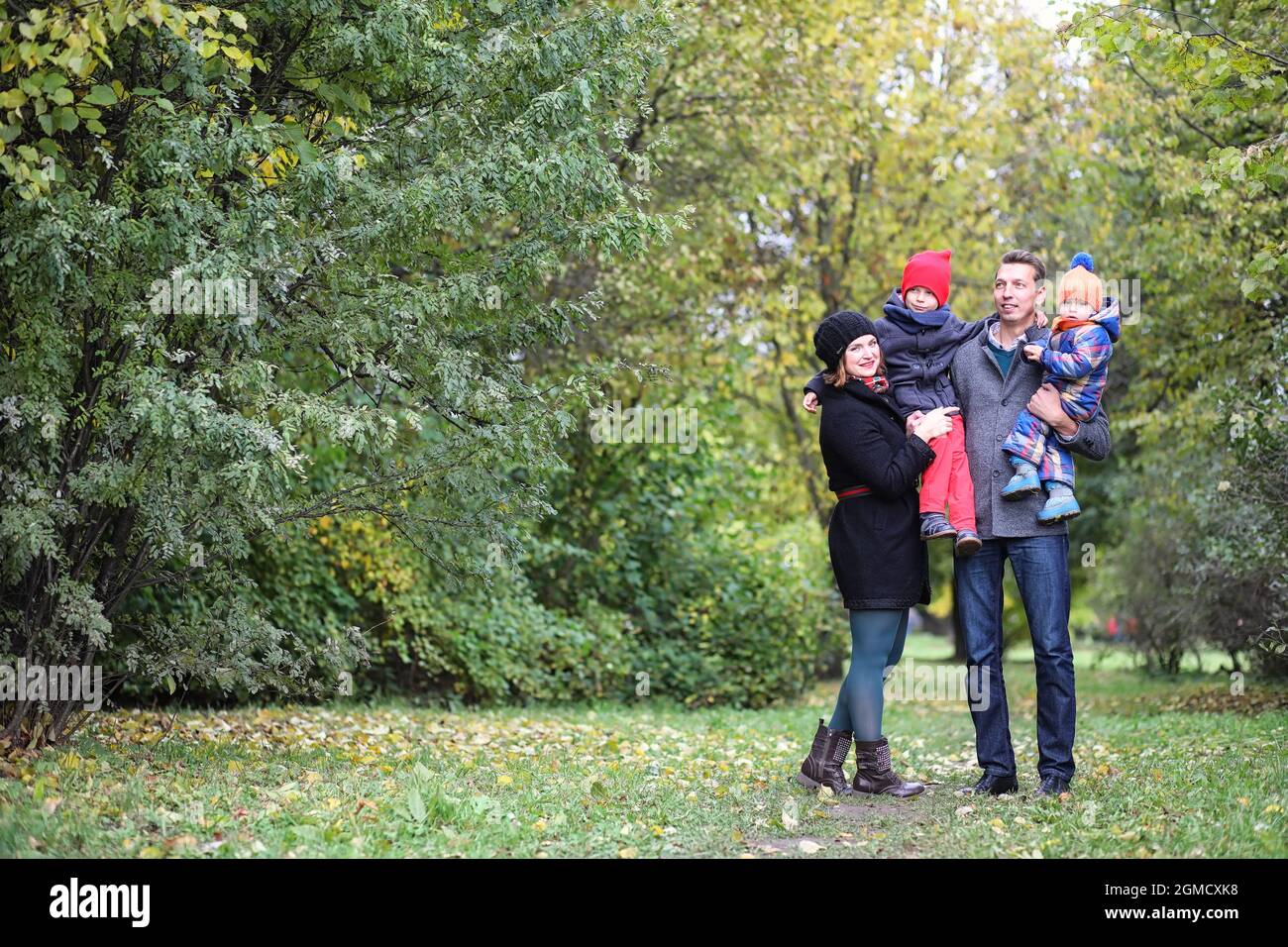 Young family with children on a walk in the park in spring Stock Photo ...