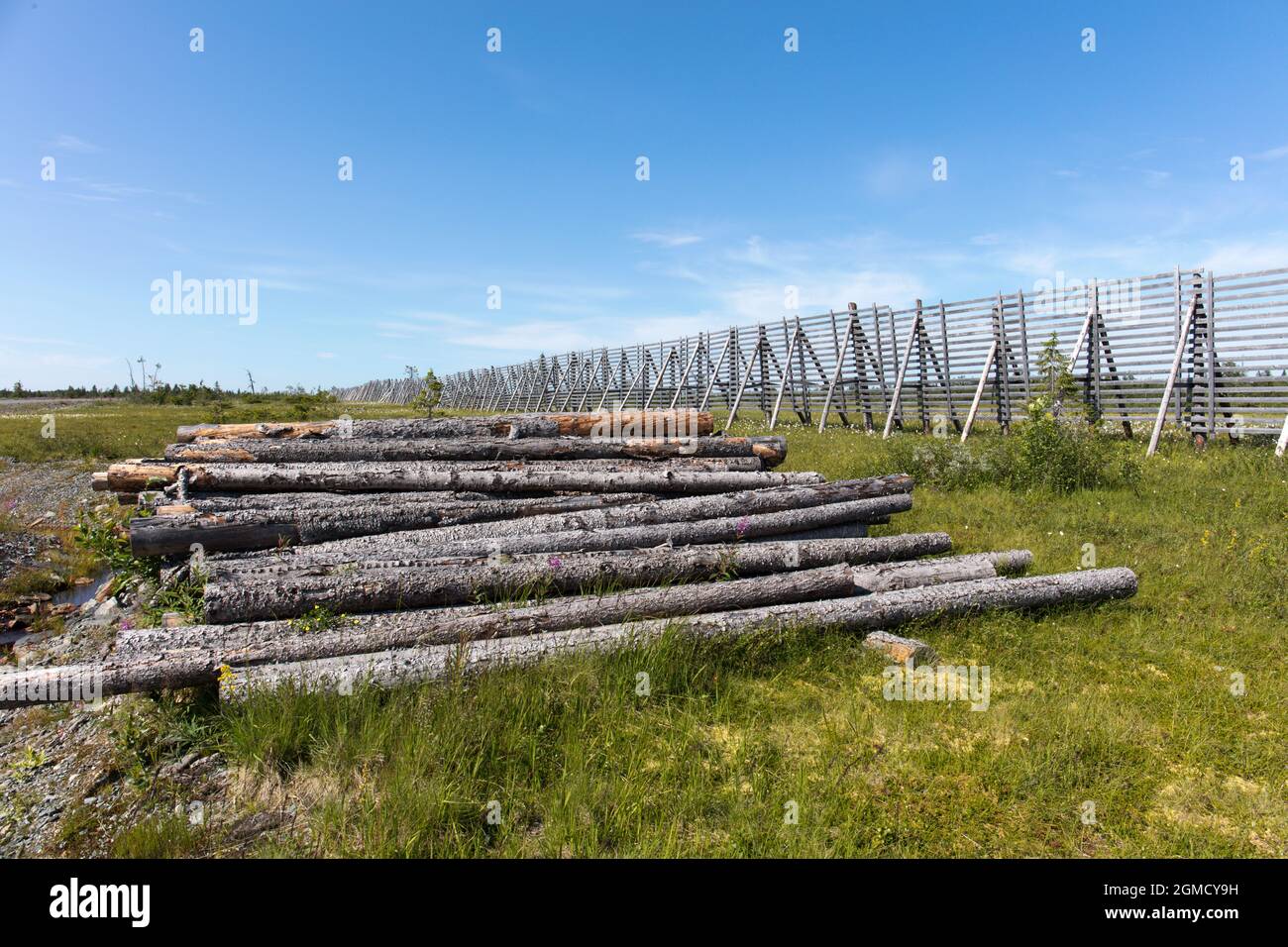 A permanent snow fence, wind protection along a rural highway. Stands ...
