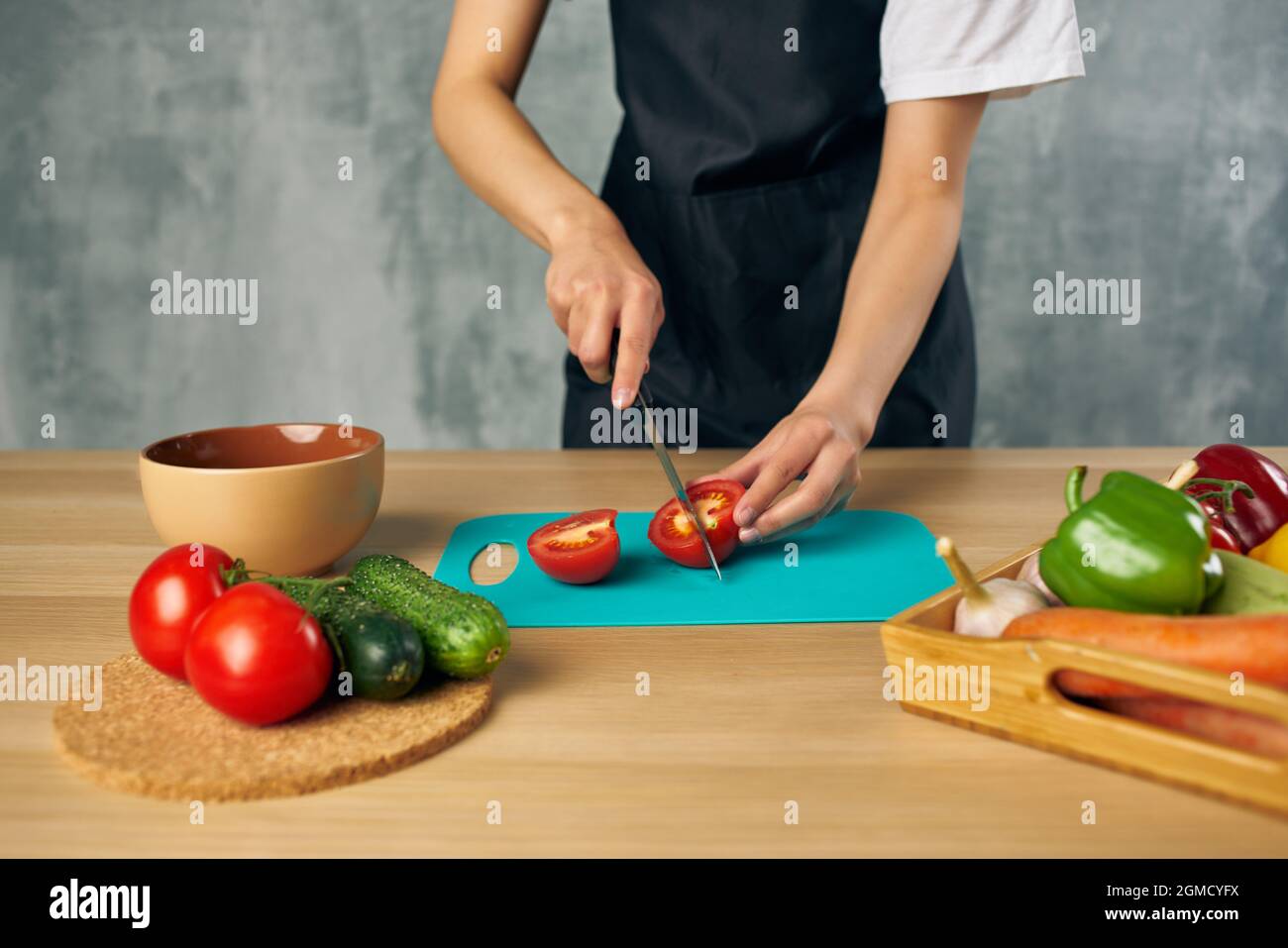 Cook in black apron Cooking healthy eating salad diet Stock Photo - Alamy