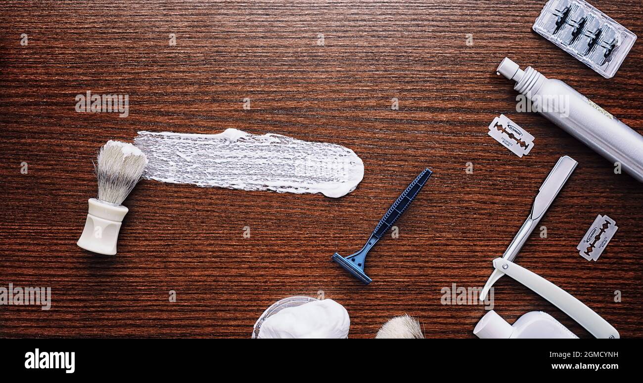 Shaving accessories on a wooden texture background. Tools. Disposable ...