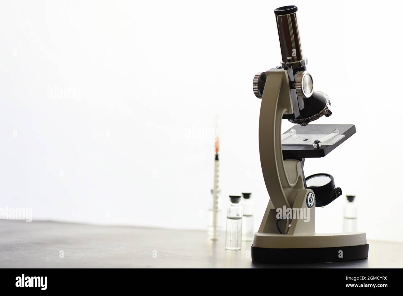 Research laboratory. Test tubes and microscope on the table on a white ...
