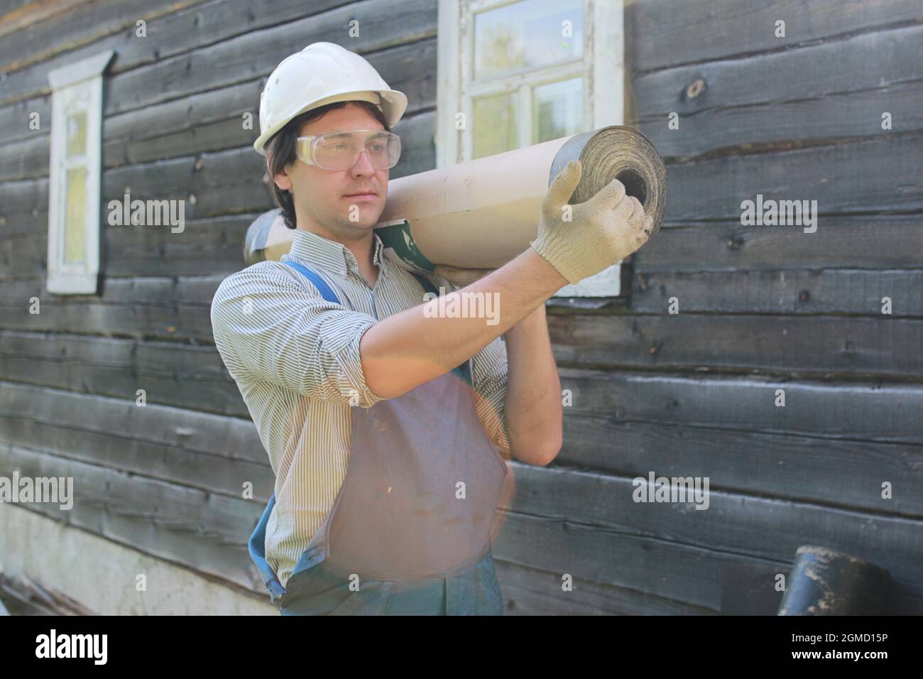a man in the form of a builder repairs a house Stock Photo - Alamy