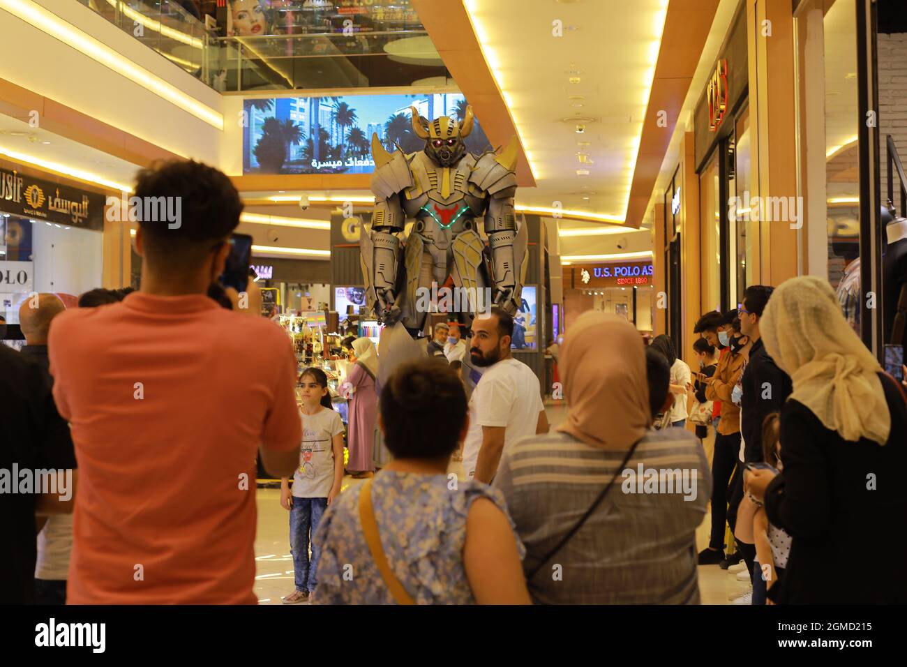 Baghdad, Iraq. 17th Sep, 2021. People watch a robot suit with a man ...