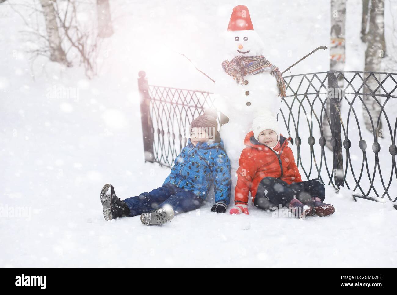 Children in the park in winter. Kids play with snow on the playground ...