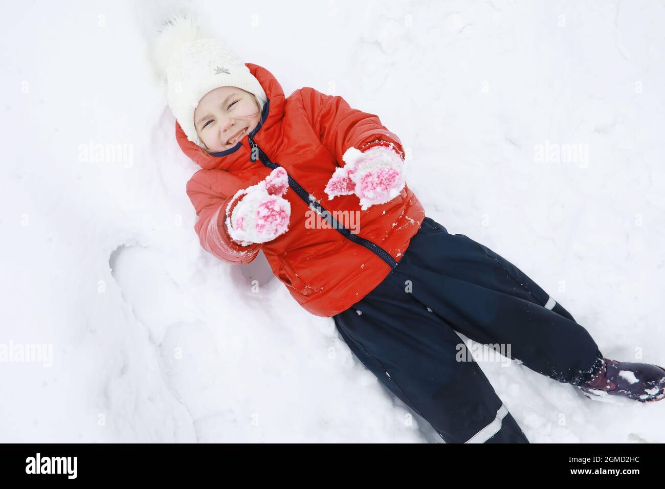 Children in the park in winter. Kids play with snow on the playground ...