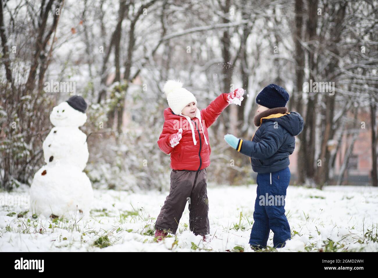 children in winter park play with snow Stock Photo - Alamy
