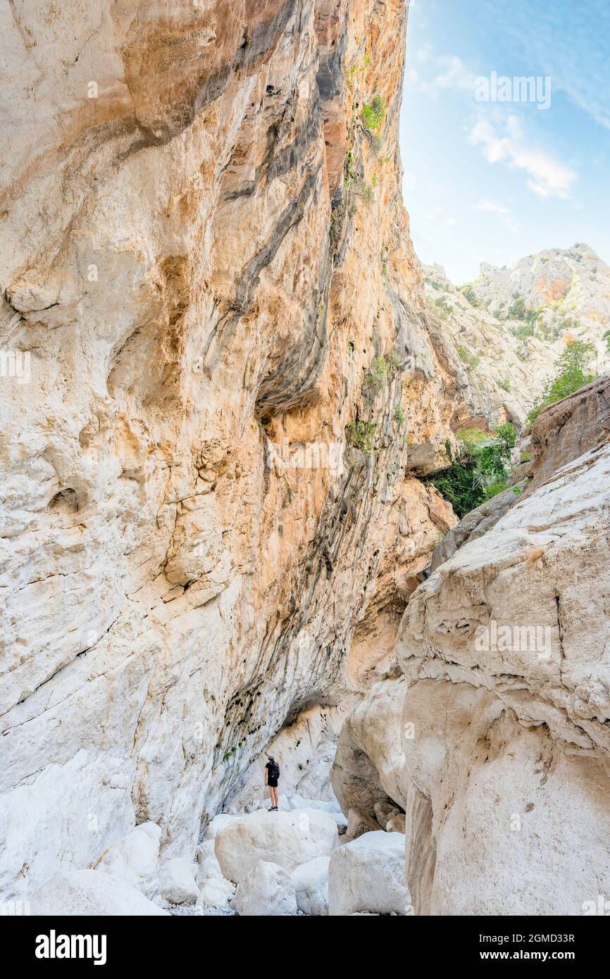 Stunning view of a person climbing a rock in the Gorropu gorge Stock ...