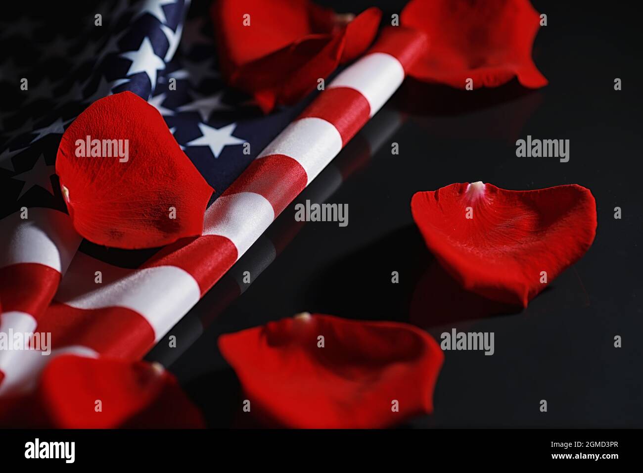 American flag and rose flower on table. Symbol of the United States of ...